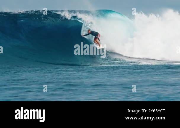Experienced surfer rides the ocean wave at the famous Sultans surf spot on the North Atolls in ...