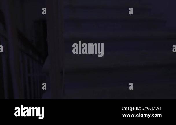 Young female on stairway in darkness. Creepy ghost woman in dress ...