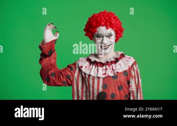 Male model as creepy fool in studio. Scary halloween man clown with ...