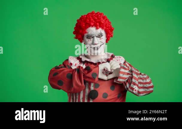 Male model as creepy fool in studio. Scary halloween man clown with ...