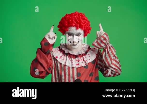 Male model as creepy fool in studio. Scary halloween man clown with ...