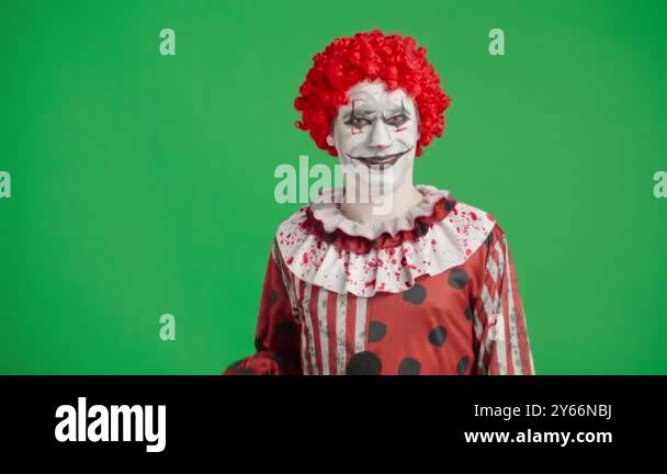 Male model as creepy fool in studio. Scary halloween man clown with ...