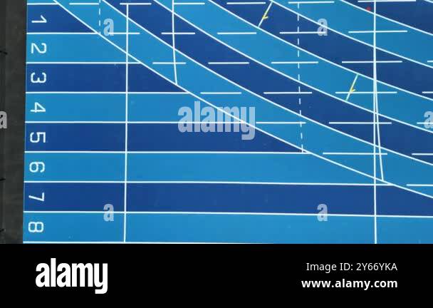 An overhead shot of a blue running track at an athletics stadium. The ...