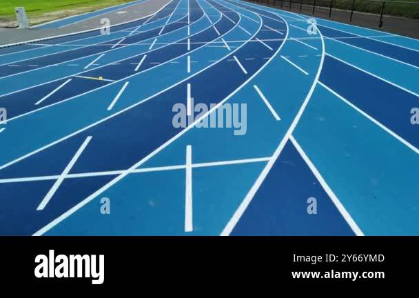 A blue running track at an athletics stadium, showing the lanes and ...