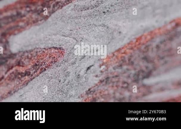 Glitter paint spill. Ink wave. Defocused red gray black color sparkling ...