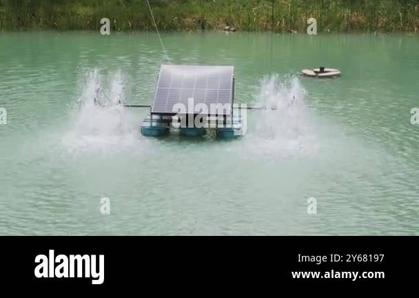 Solar-powered water aerator system with rotating paddles in a pond for ...