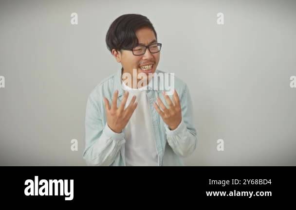Frustrated young chinese man, crazy mad, shouting, arms raised. emotion ...
