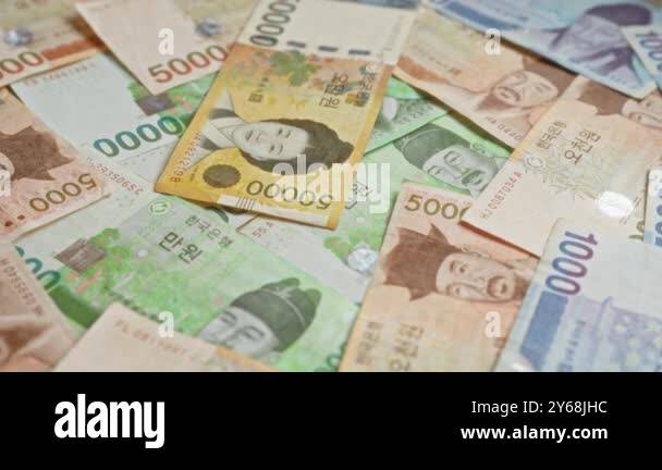 South korean banknotes scattered, featuring various denominations ...