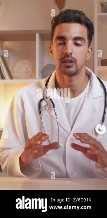 Vertical video. Virtual appointment. Male doctor. Medical help ...
