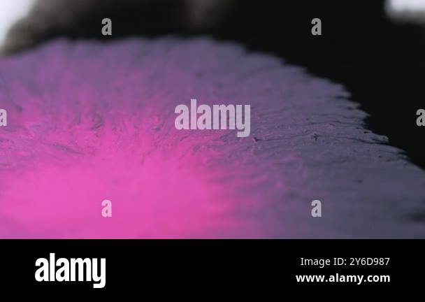 Paint blotch. Sparkling fluid leak. Defocused pink black color drop ...