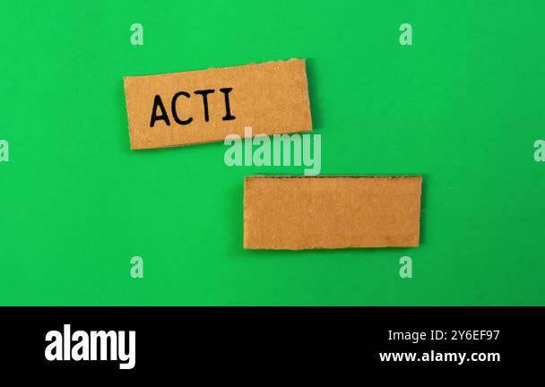 Action plan message writing on ripped torn cardboard paper on green background. Conceptual ...