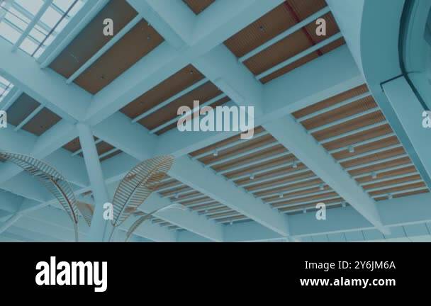 A modern architectural ceiling with a unique design, featuring wooden ...