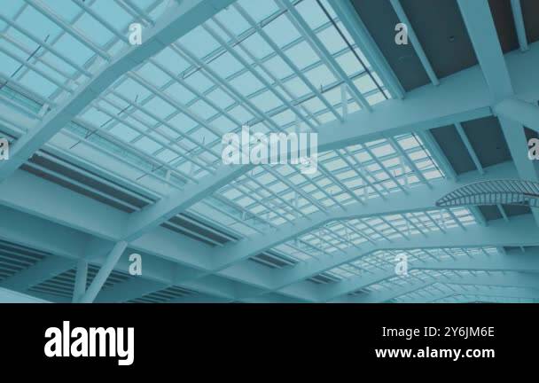 A modern architectural ceiling with a grid of glass panels allowing ...