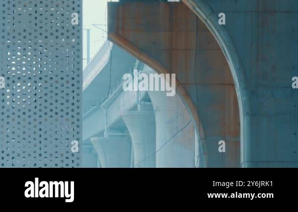 A close-up view of a concrete bridge structure with arches, showcasing ...