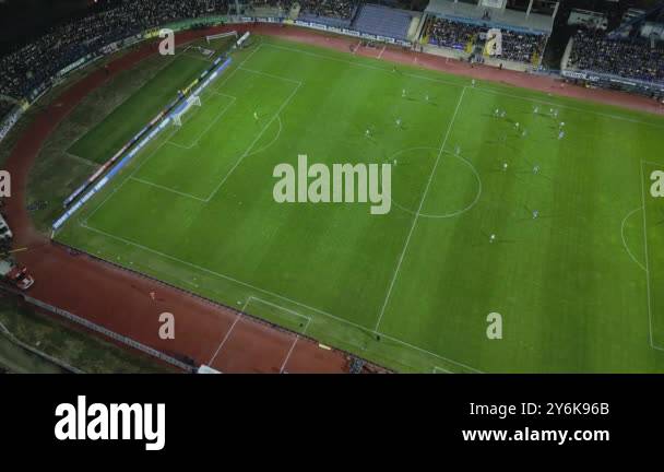 Drone footage capturing an aerial view of a football match in progress ...