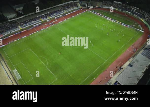Drone footage capturing an aerial view of a football match in progress ...