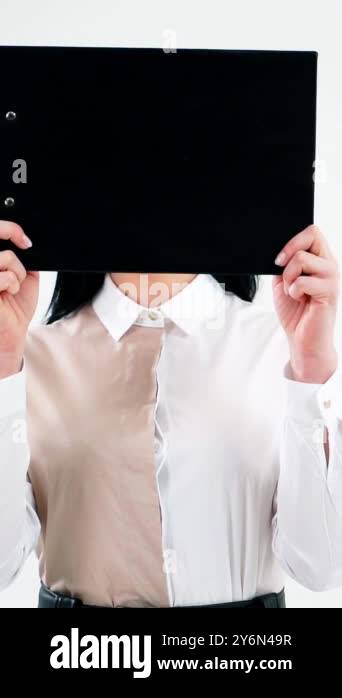 Black folder hides woman face. Attractive secretary opens her face ...