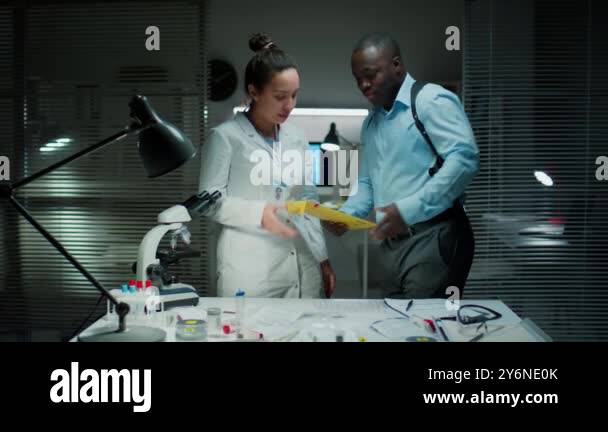 Female forensic scientist using microscope in crime lab, then ...