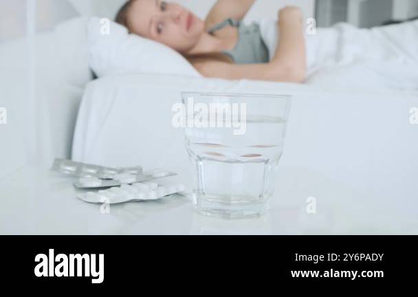 Sick woman with cold and flu takes medicine, drugs, pills in blister ...