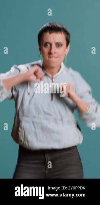 Vertical video Groovy bold funky woman dancing and fooling around in ...