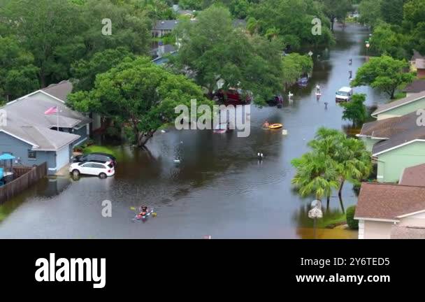 Aftermath of hurricane Debby flooding natural disaster. Kayak boats ...