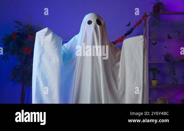 Person dressed as ghost posing at camera. Funny halloween ghost in ...