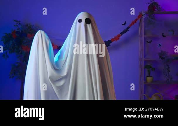 Person dressed as ghost posing at camera. Funny halloween ghost in ...