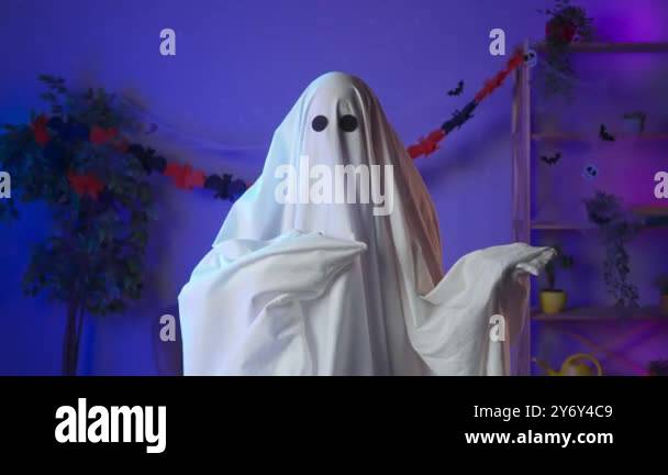 Person dressed as ghost posing at camera. Funny halloween ghost in ...