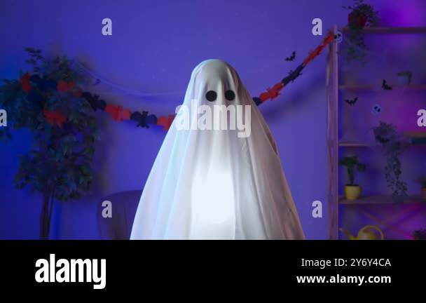 Person dressed as ghost posing at camera. Funny halloween ghost in ...
