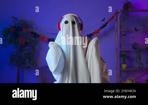 Person dressed as ghost posing at camera. Funny halloween ghost in ...