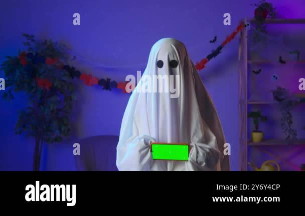 Person dressed as ghost posing at camera. Funny halloween ghost in ...