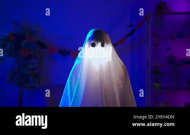 Person dressed as ghost posing at camera. Funny halloween ghost in ...