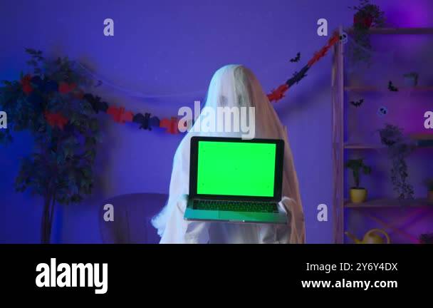 Person dressed as ghost posing at camera. Funny halloween ghost in ...