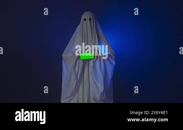 Person dressed as ghost posing at camera. Funny halloween ghost in ...