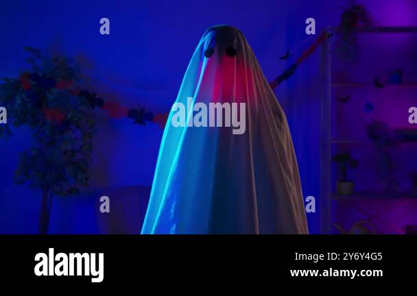 Person dressed as ghost posing at camera. Funny halloween ghost in ...