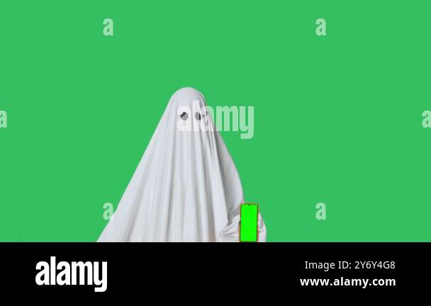 Person dressed as ghost posing at camera. Funny halloween ghost in ...