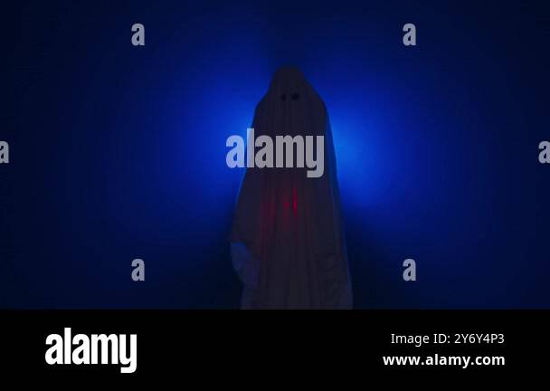 Person dressed as ghost posing at camera. Funny halloween ghost in ...