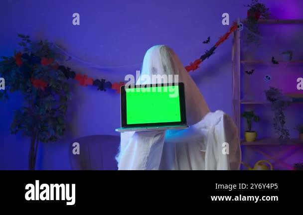 Person dressed as ghost posing at camera. Funny halloween ghost in ...