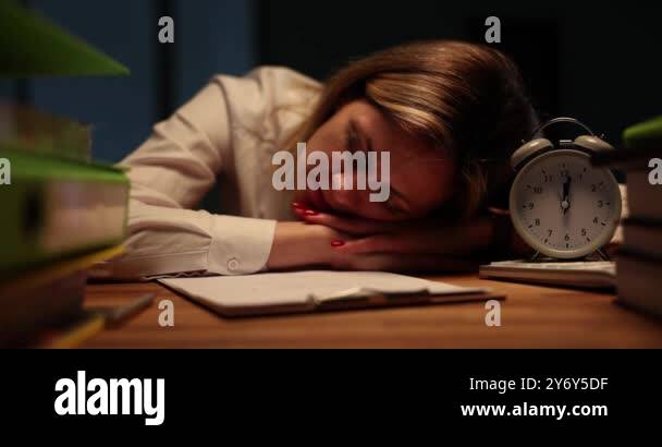 Exhausted female worker lies on hands put on office table resting near ...