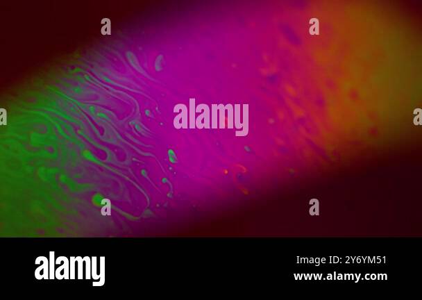 Lava lamp liquid. Lsd fluid drops. Defocused neon green purple pink ...