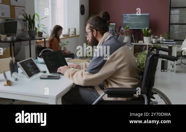 Medium full side shot of young Middle Eastern male programmer in ...