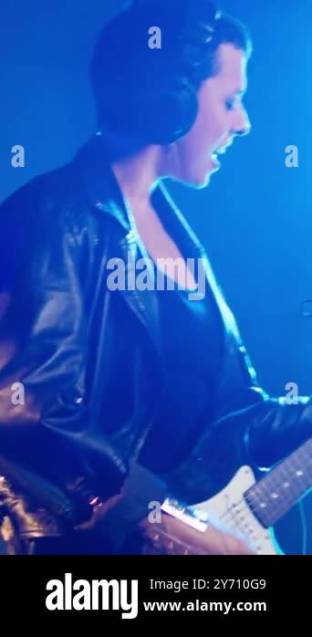 Vertical video Punk rock artist woman sings live with confidence in her ...