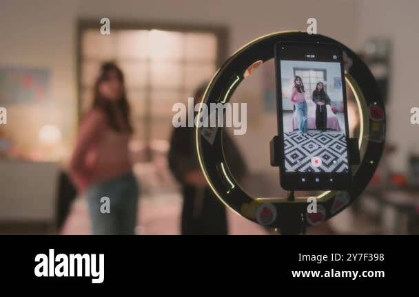 Smartphone placed in holder with ring light recording video of two ... Smartphone placed in holder with ring light recording video of two ...