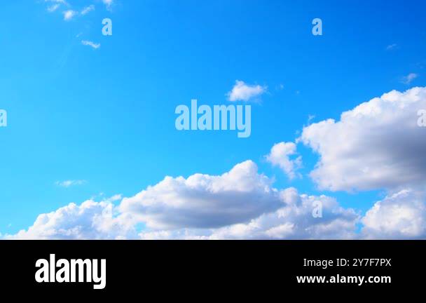 Beautiful white clouds in the sunny blue sky. Volumetric light effect ...