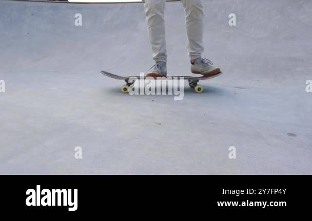 close-up shot captures the legs of an unrecognized skater as they ...