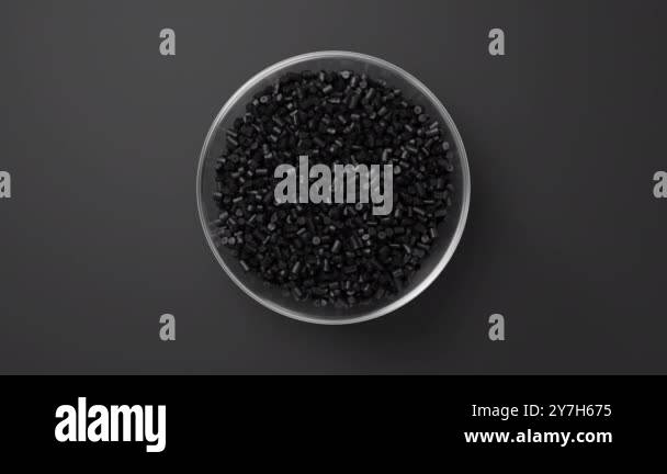 Rotating glass bowl with black plastic polypropylene granules ...