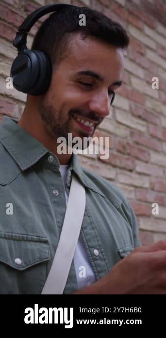 Vertical side attractive young Caucasian man nodding listening to music ...