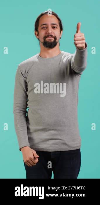 Vertical video Portrait of upbeat man showing thumbs up sign gesturing ...