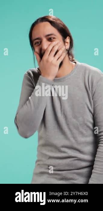 Vertical video Portrait of cheerful man laughing hard, amused by funny ...