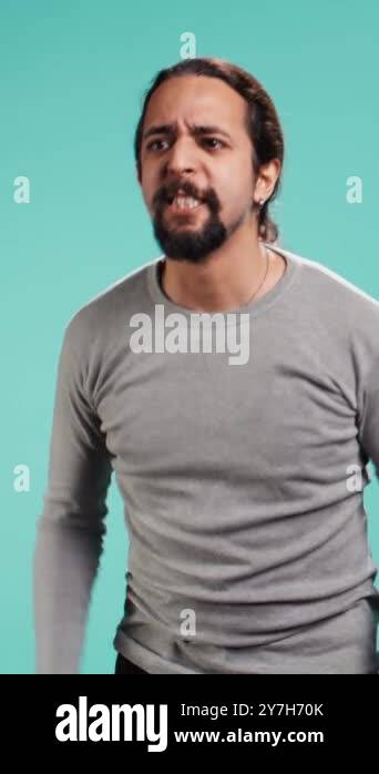Vertical video Portrait of irate man feeling outraged, yelling at ...